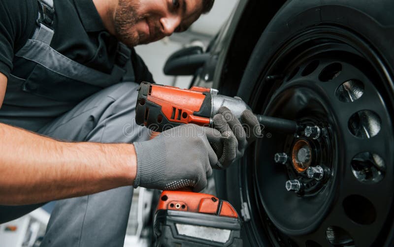 Modern Vehicle. Man in Uniform is Working in the Autosalon at Daytime ...