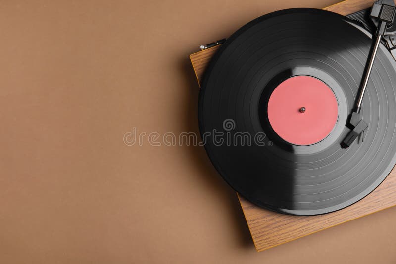 Modern Vinyl Record Player with Disc on Brown Background, Top View ...