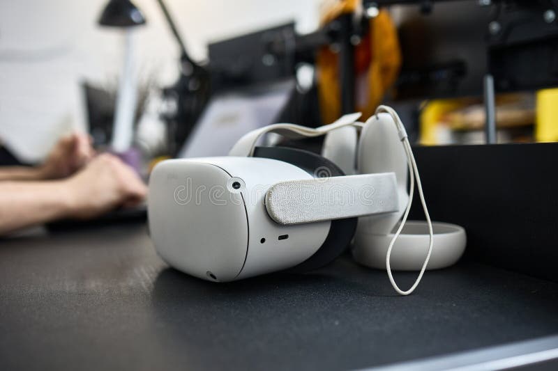 Modern Virtual Reality Headset on Desk with Blurred Person Using ...