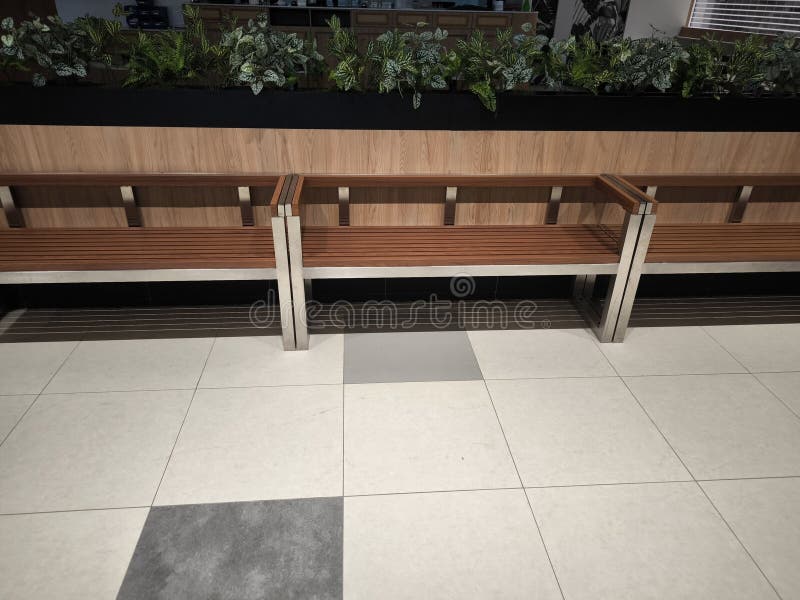 Modern Waiting Area with Wooden Benches and Greenery Stock Photo ...