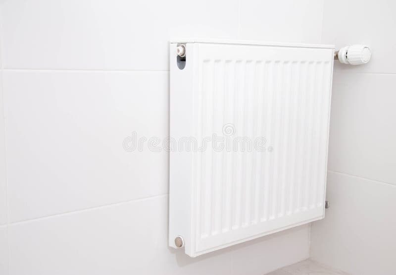 Modern Wall-mounted Heating Radiator with Thermostat on the White Wall ...