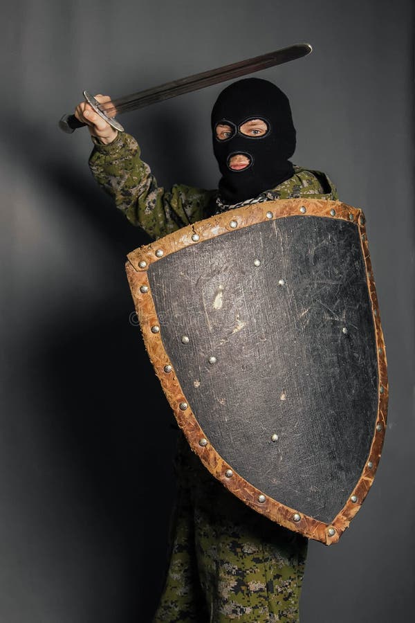Modern Warrior with Medieval Weapons in His Hands. a Soldier Defends ...
