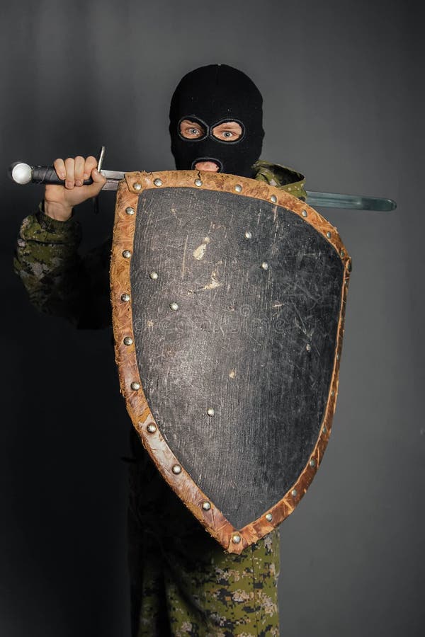 Modern Warrior with Medieval Weapons in His Hands. a Soldier Defends ...