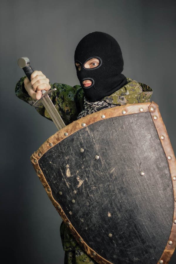 Modern Warrior with Medieval Weapons in His Hands. a Soldier Defends ...