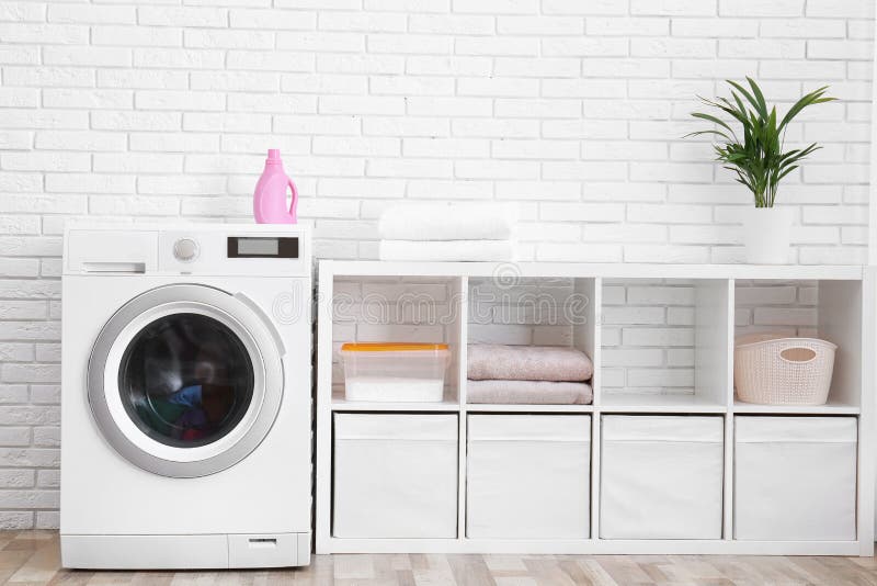 Modern Washing Machine Near Brick Wall in Laundry Room Stock ...