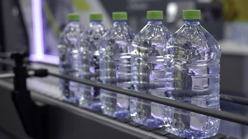 The Modern Water Bottling Process Utilizes Clear Plastic Containers for ...