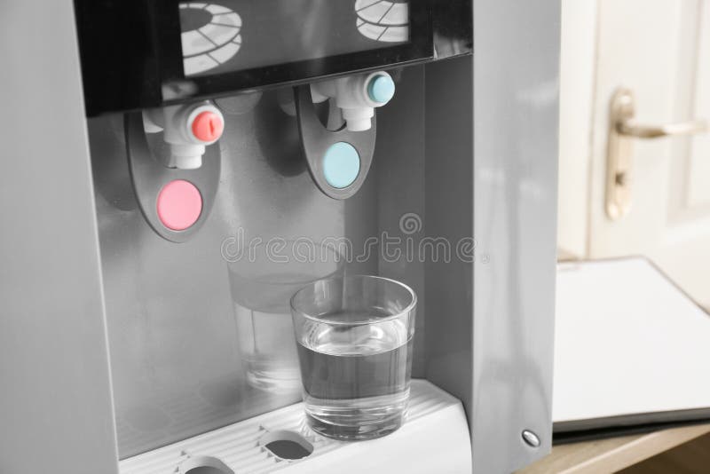 Modern Water Cooler with Glass on Table in Office Stock Photo - Image ...