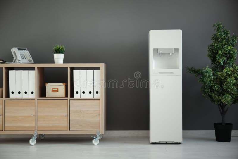 Modern Water Cooler Against Gray Wall Stock Photo - Image of copy ...