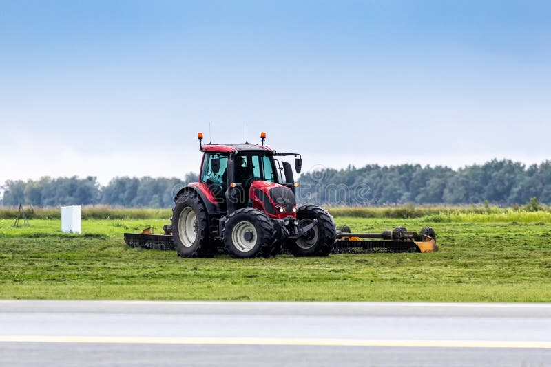 Modern Wheel Tractor with Lawn Mower by the Road Stock Photo - Image of ...