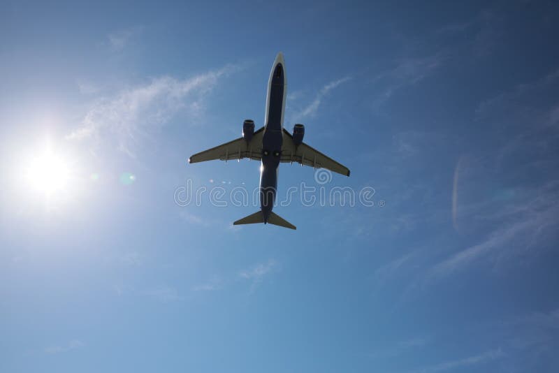 Modern White Airplane Flying in Sky, Bottom View Stock Photo - Image of ...