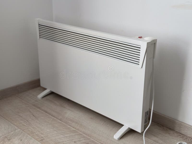 Modern White Electric Heater Placed Against a Plain Wall. Functional ...