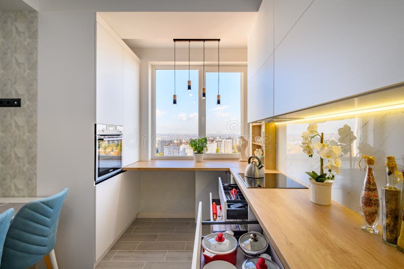 A Modern White Kitchen with Drawers Extended Stock Photo - Image of ...