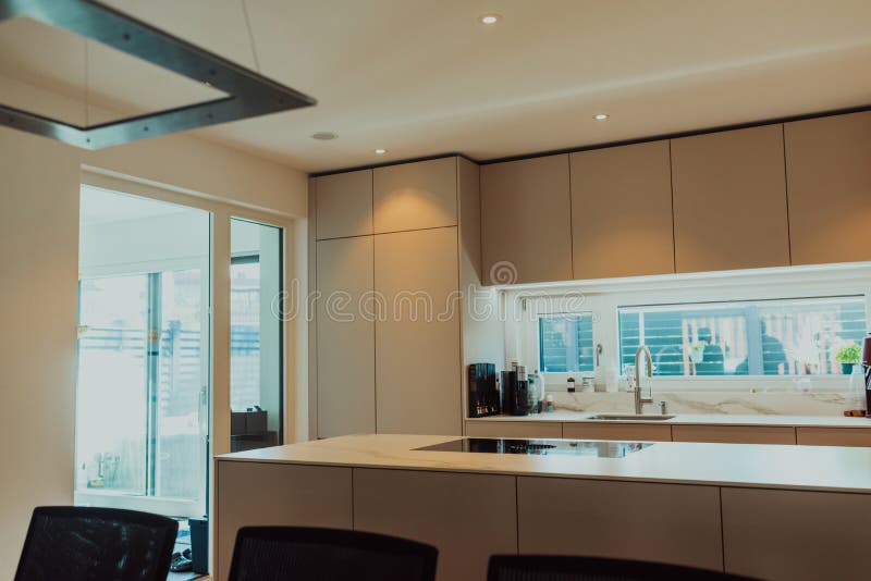 Modern White Kitchen with Electronic Devices and Decorative Items Stock ...