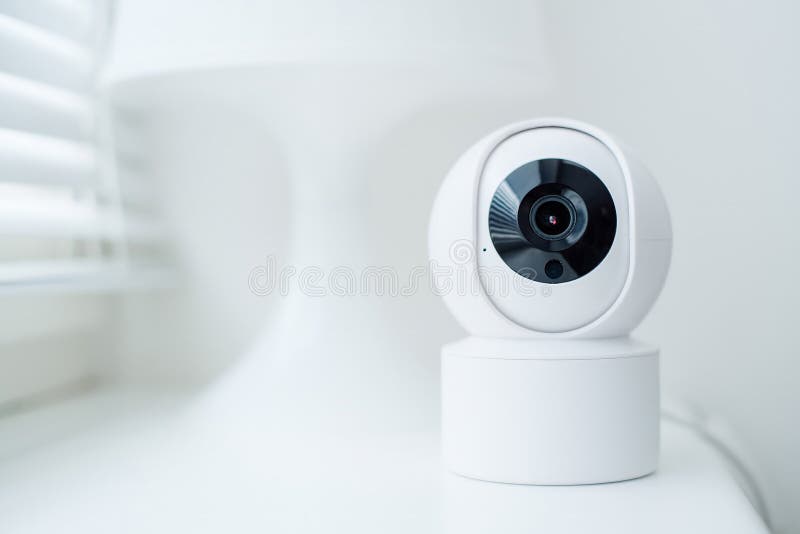 Modern White Security Camera on a Table by a Window. Suitable for ...