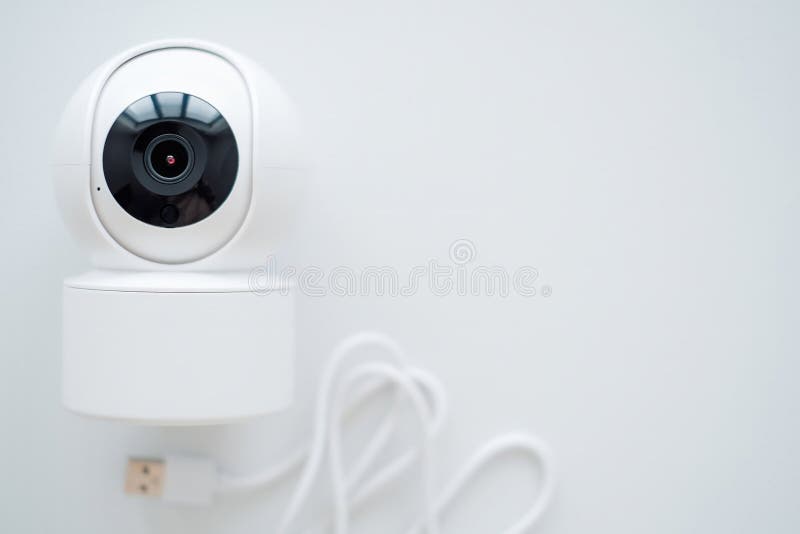 Modern White Security Camera on a Table by a Window. Suitable for ...