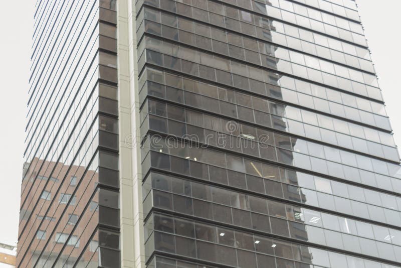 Modern White Skyscraper with Rectangle Windows Reflecting a Brick ...