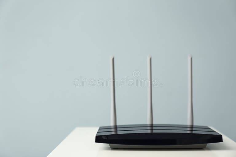 Modern Wi-fi Router on Light Table Against Light Background Stock Photo ...