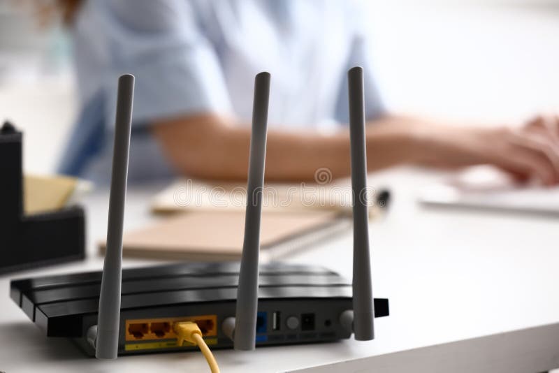 Modern Wi-fi Router on Light Table in Office Stock Photo - Image of ...