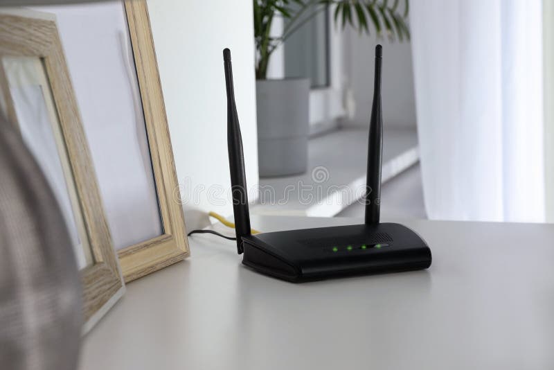 Modern Wi-Fi Router on White Table in Room Stock Image - Image of ...