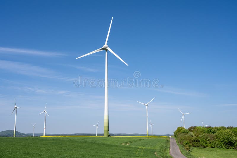 Modern Wind Energy Plants with Green Fields Stock Image - Image of ...