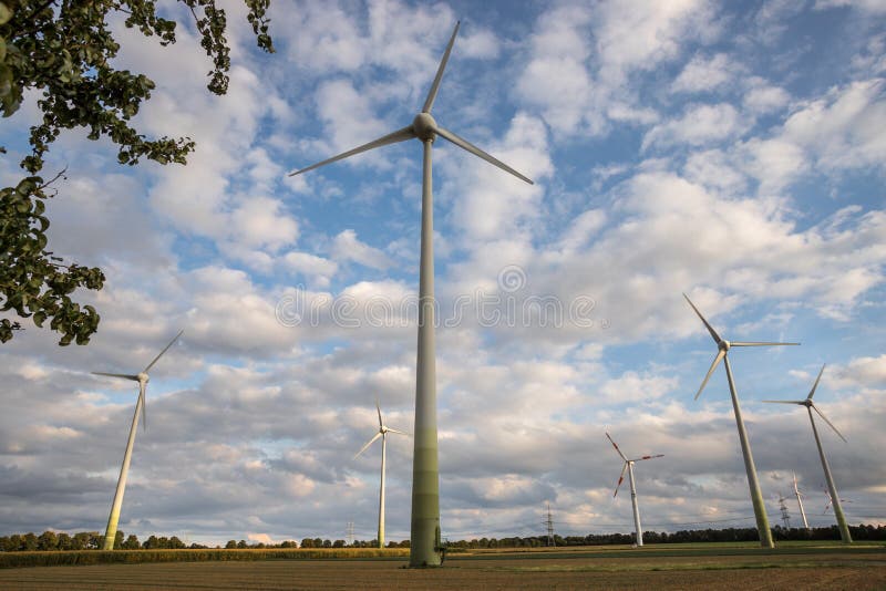 Modern Wind Turbines in Front of a Cloudy Sky Stock Photo - Image of ...