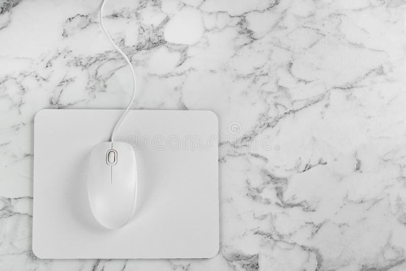 Modern Wired Optical Mouse and Pad on Marble Table, Top View. Space for ...