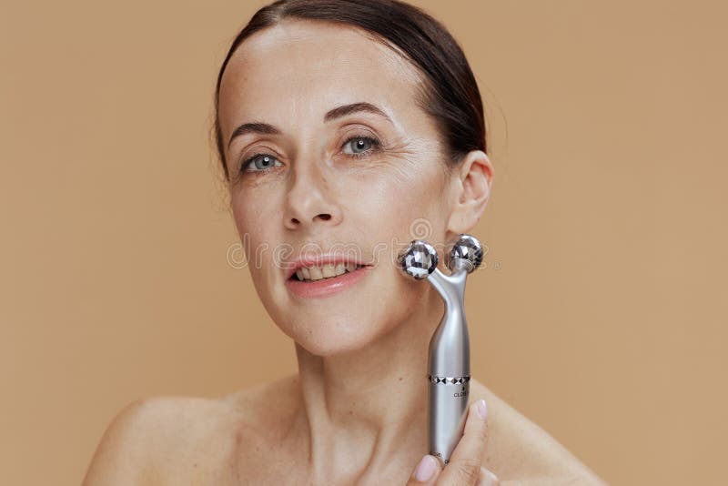 Woman with Electric Massager on Beige Background Stock Image - Image of ...