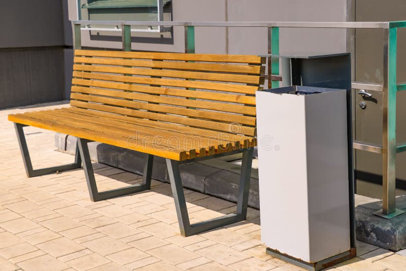 Modern Wooden Bench and a Trash Can Outside of a Building Stock Image ...