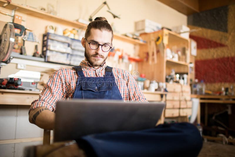 Modern Worker Using Laptop stock photo. Image of artisan - 133397734