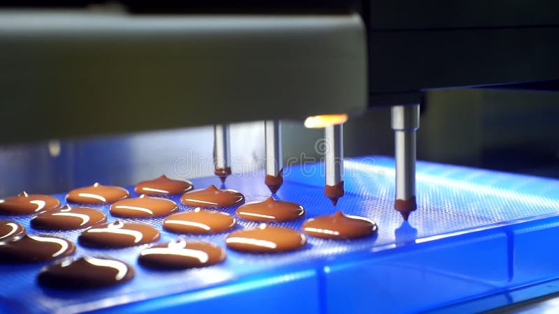 Liquid Chocolate Mass Poured into a Mold Moves Along a Conveyor. Close ...