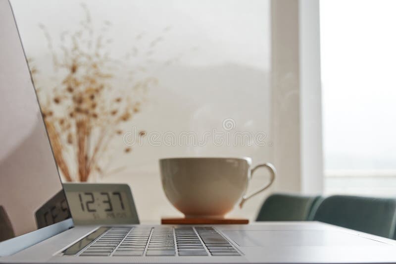 Modern Working Laptop on the Table with Coffee Cup and Digital Clock ...