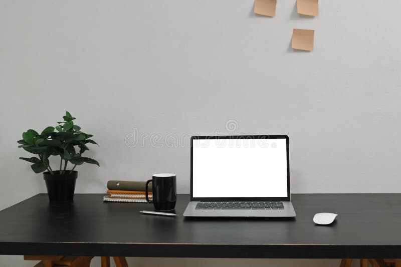 Modern Workstation with Blank Laptop Screen, Notebooks, and a Green ...