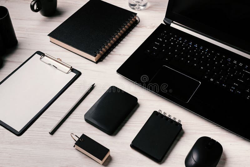 Modern Workstation with a Laptop Computer, Notebook and a Stack of ...