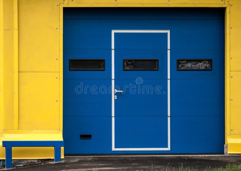 Modern Yellow Garage Wall with Closed Blue Gate Stock Image - Image of ...