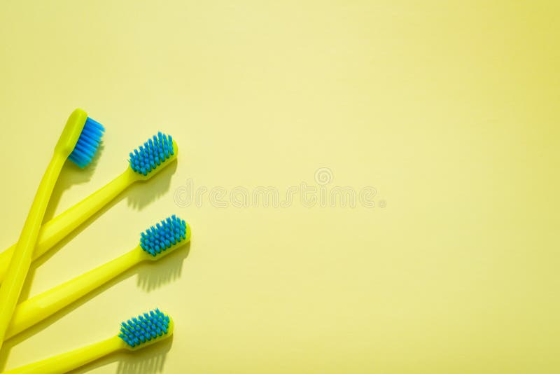 Modern Yellow Kids Toothbrushes on a Yellow Background. Copy Space for ...