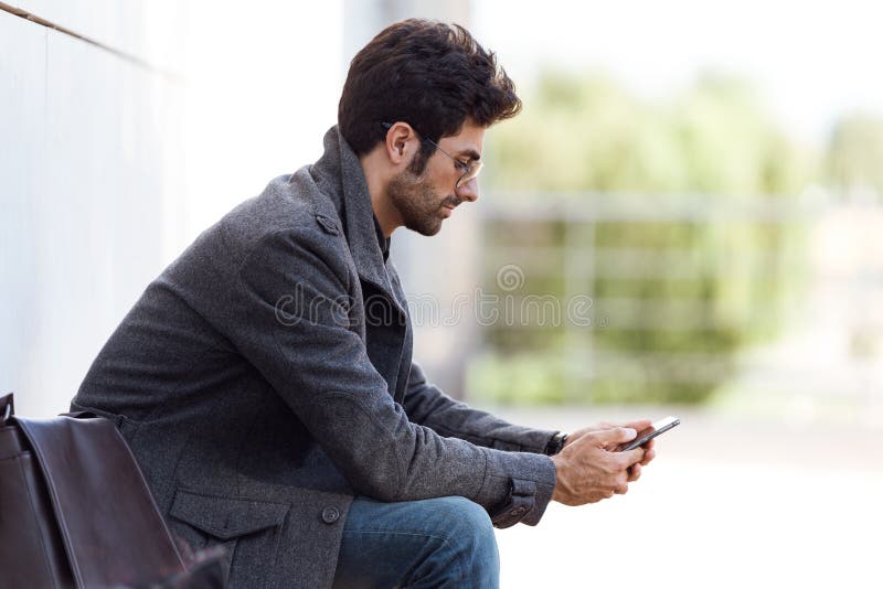 Modern Young Man Using His Mobile Phone in the Street. Stock Photo ...