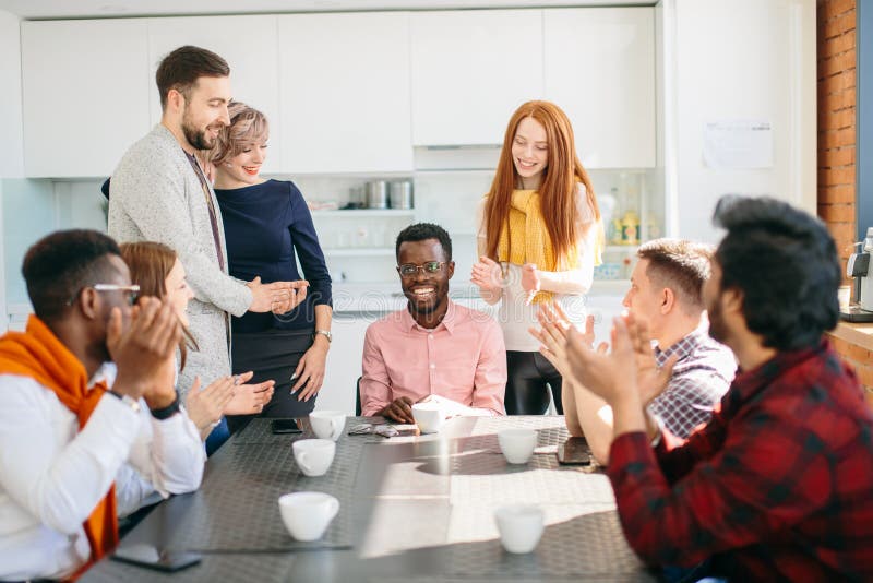 Modest Smiling Guy is Sitting Topside at the Able among His Friends ...
