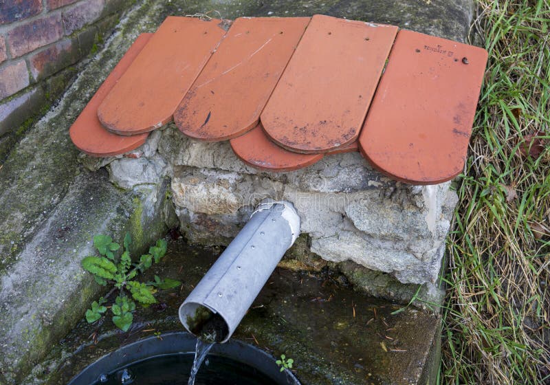 Modified Natural Spring. Water Flows Out of the Felt Pipe Stock Image ...