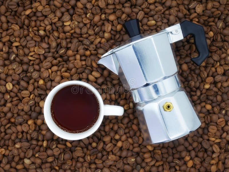Moka Pot Coffee Maker and Cup on Coffee Beans Texture Background.Top ...