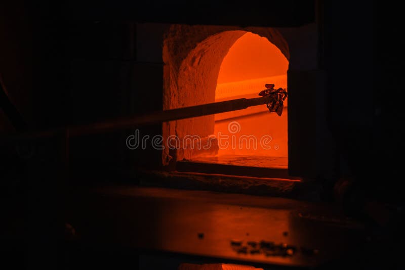 Molten Glass on a Blowpipe is Inside of an Open Furnace, Glass Blowing ...