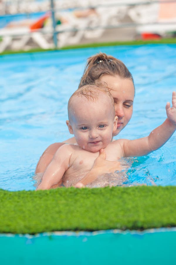 Mom and Baby Have a Rest in Stock Photo - Image of beach, grass: 179133274