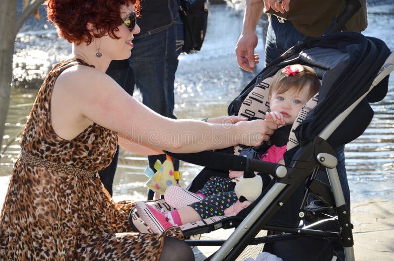 Mom with Baby in Stroller stock photo. Image of head - 28272666