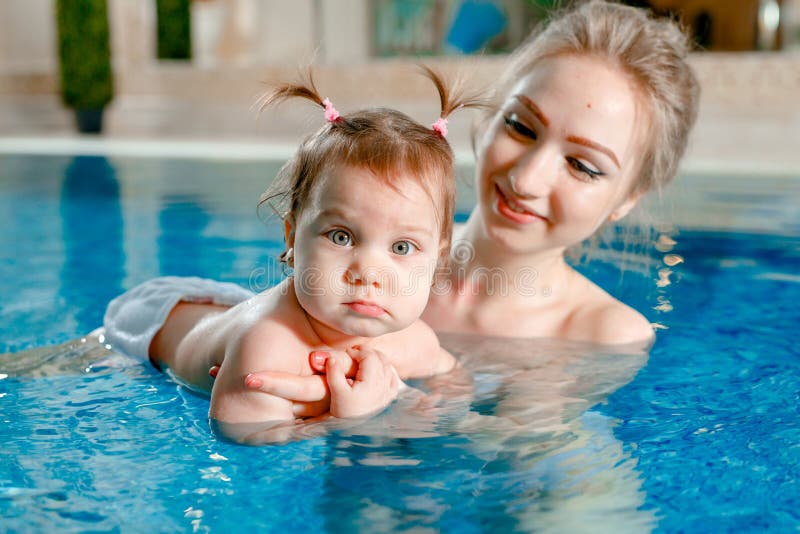 Mom and Baby Swim in the Pool. Stock Photo - Image of activity, family ...