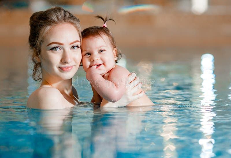 Mom And Baby Swim In The Pool. Stock Image - Image of baby, holding ...