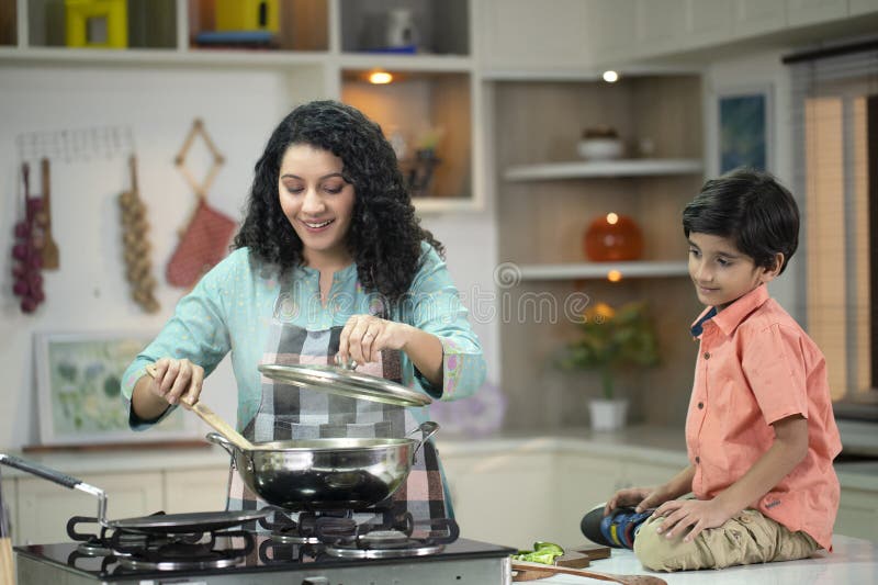 Mom Cooking in Kitchen stock image. Image of sitting - 325935227
