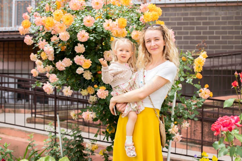 Mom and Daughter Admire the Yellow Rose Bushes, Take Selfies, Take ... Mom and Daughter Admire the Yellow Rose Bushes, Take Selfies, Take ...