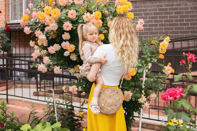 Mom and Daughter Admire the Yellow Rose Bushes, Take Selfies, Take ... Mom and Daughter Admire the Yellow Rose Bushes, Take Selfies, Take ...