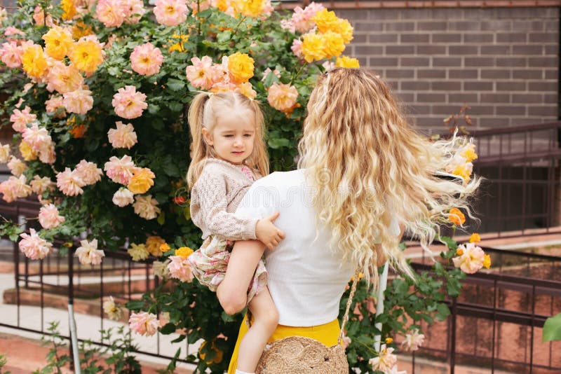 Mom and Daughter Admire the Yellow Rose Bushes, Take Selfies, Take ... Mom and Daughter Admire the Yellow Rose Bushes, Take Selfies, Take ...