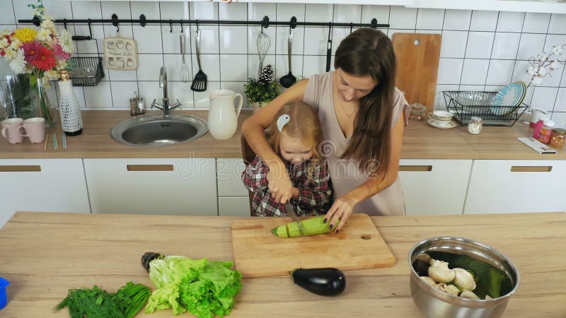 Mom and Daughter Cooking Vegetables at the Kitchen Stock Footage ...