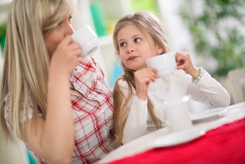 Mom and Daughter Drinking Tea Together Stock Photo - Image of female ...